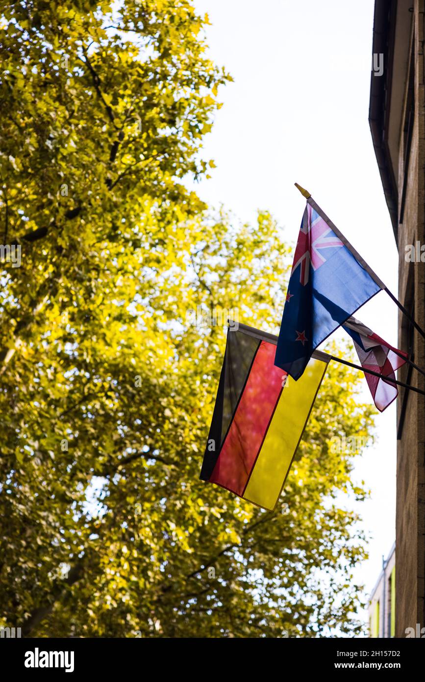 Vertical shot of hanging Australian and German flags on a building ...