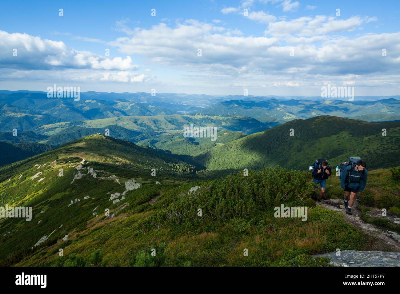 CARPATHIANS, UKRAINE - AUGUST 13, 2016: Two young men with backpacks ...