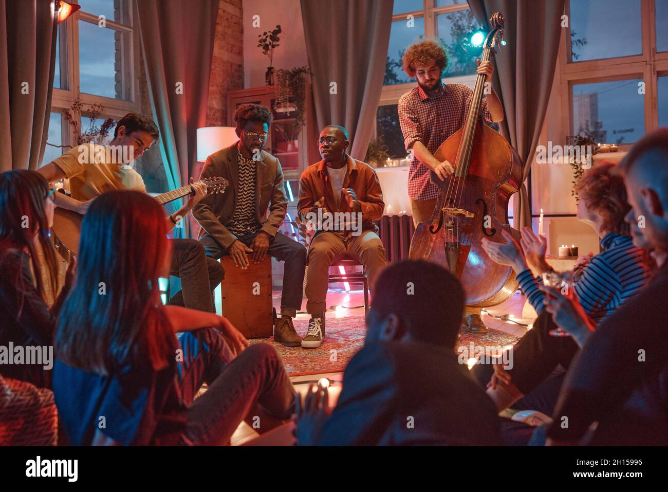 Musical band of young men playing musical instruments during performing ...