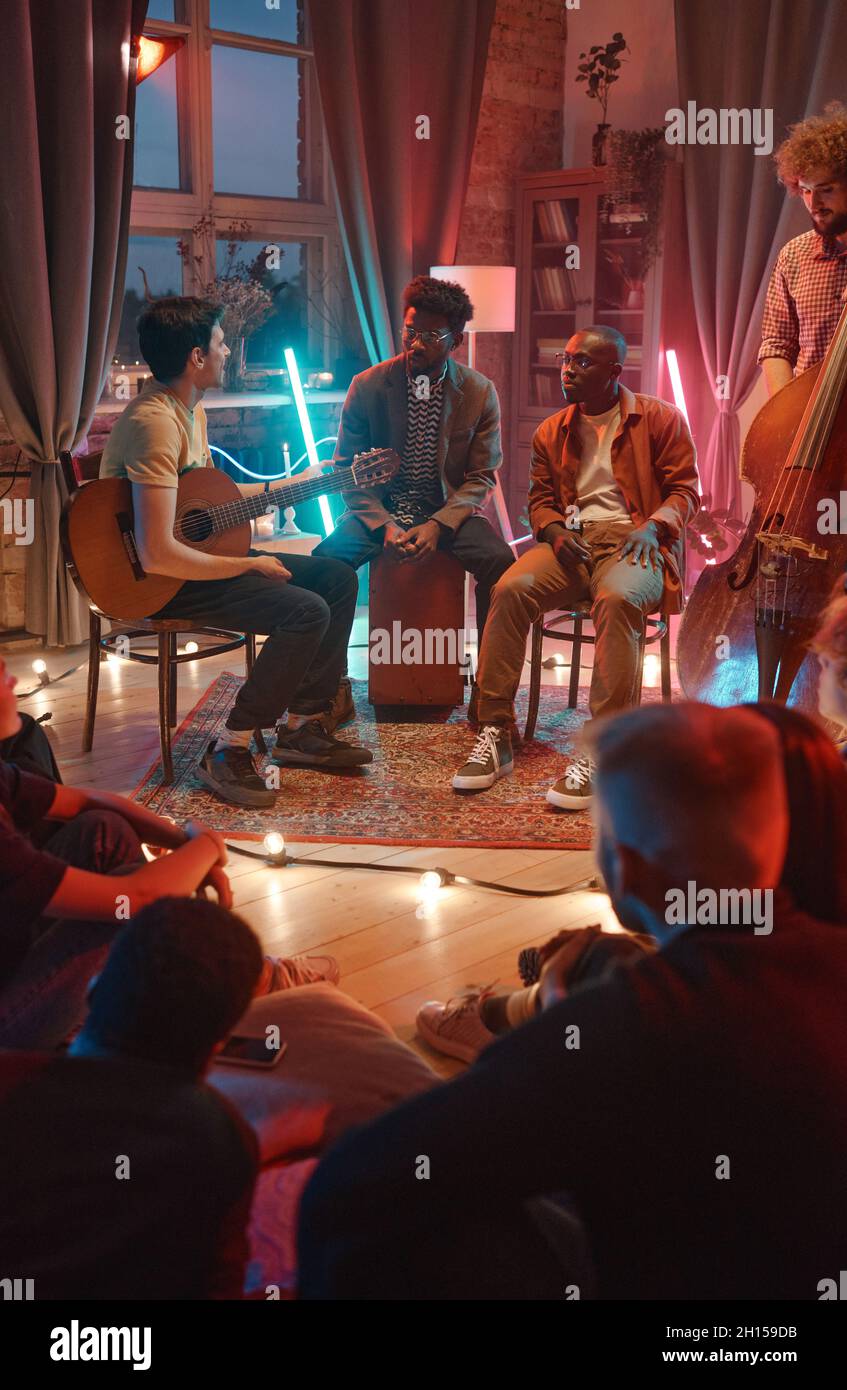 Music group of men discussing the beginning of their performance with ...