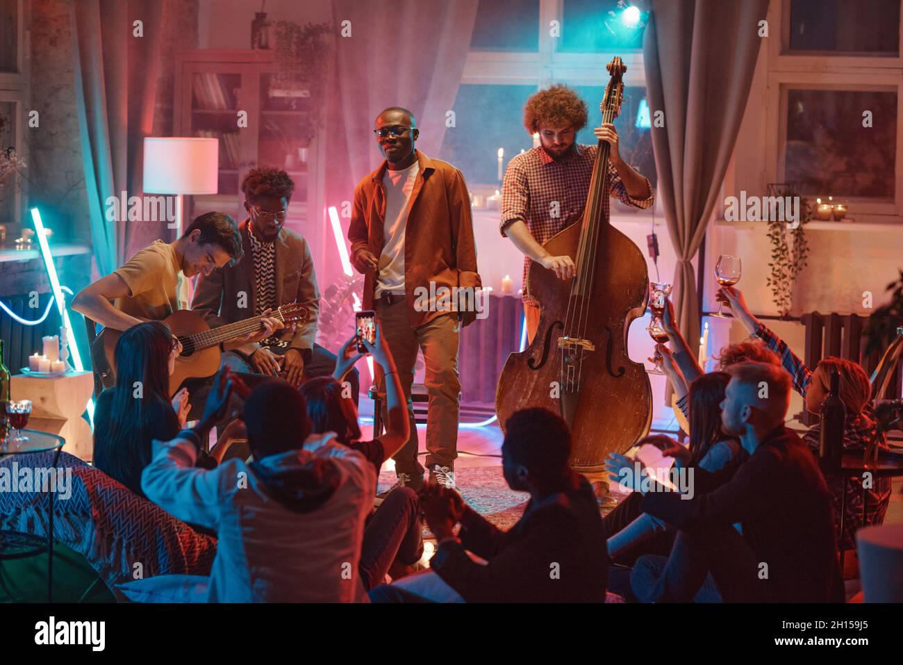 Guys playing on different musical instruments for people during their ...