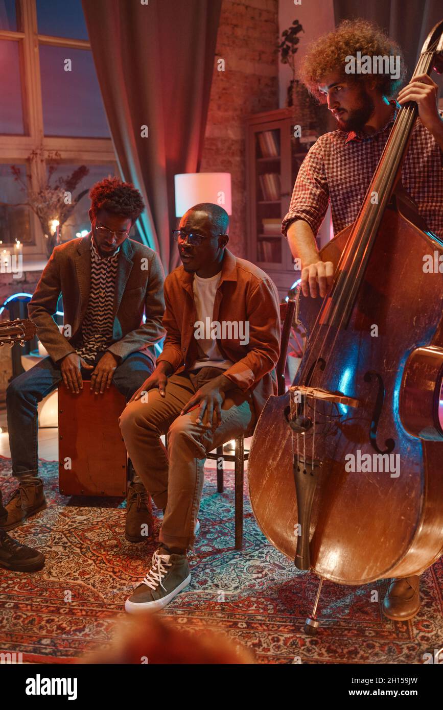 Musical group playing on musical instruments while performing in the ...