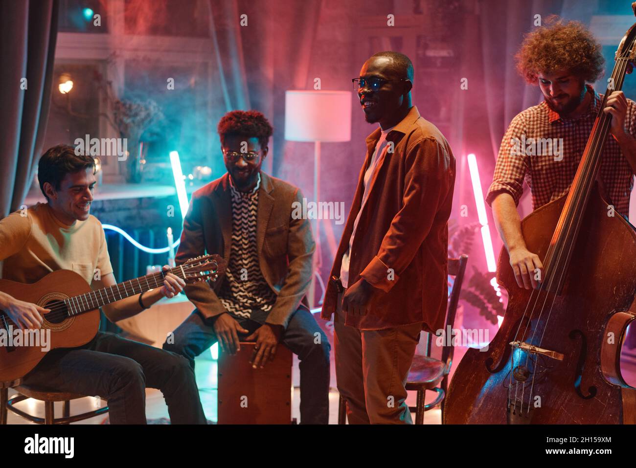 Music band playing musical instruments they rehearsing in the studio ...