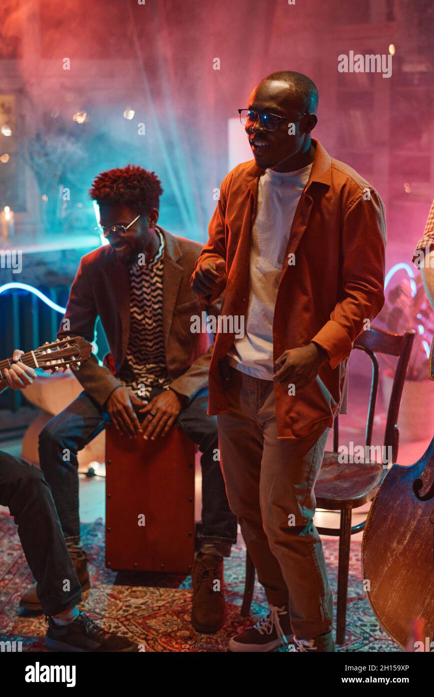 African singer performing together with his musical band in the night ...