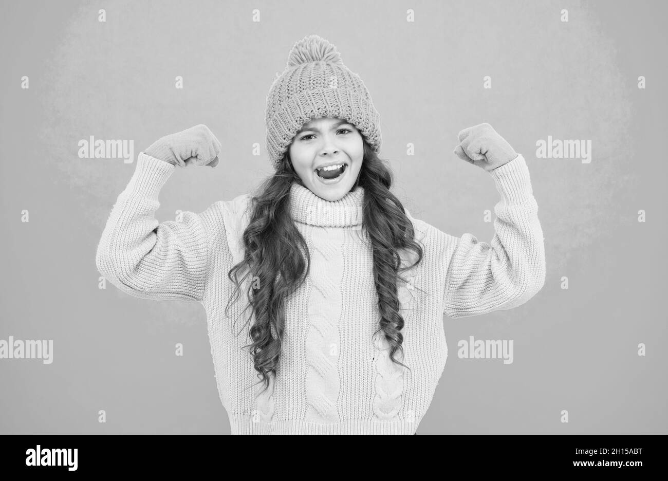 Energy charge. Child cute girl hat and gloves show biceps gesture of ...