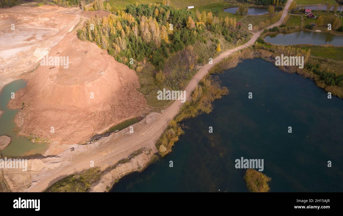 Open pit gravel mining. Little lake or pond of unusual shape with a ...