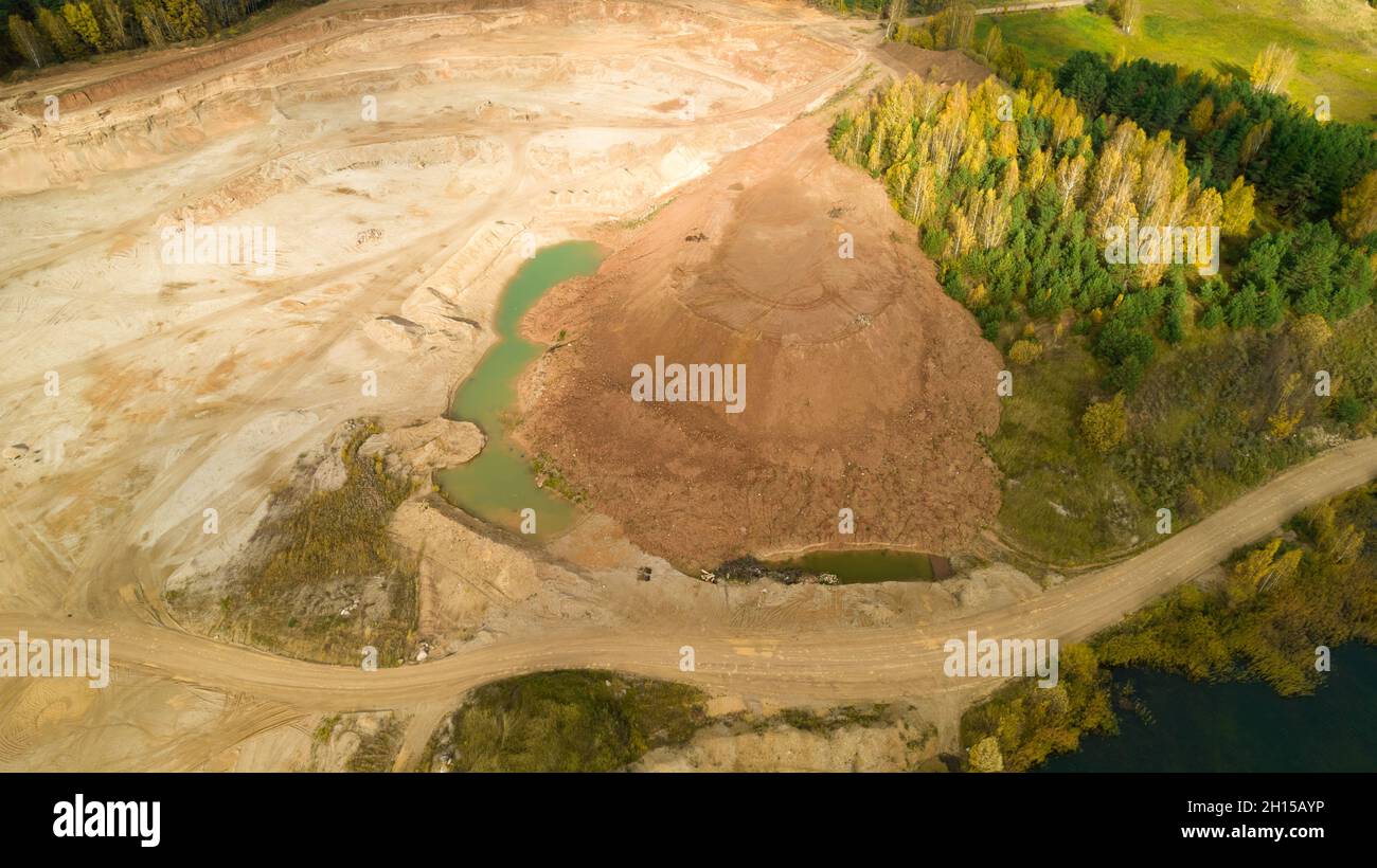 Open pit gravel mining. Little lake or pond of unusual shape with a ...