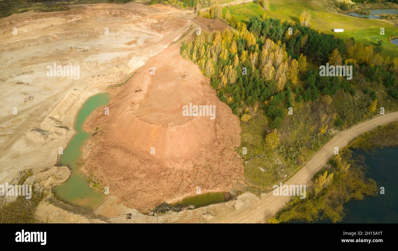 Open pit gravel mining. Little lake or pond of unusual shape with a ...