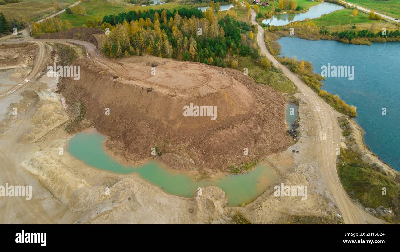 Open pit gravel mining. Little lake or pond of unusual shape with a ...