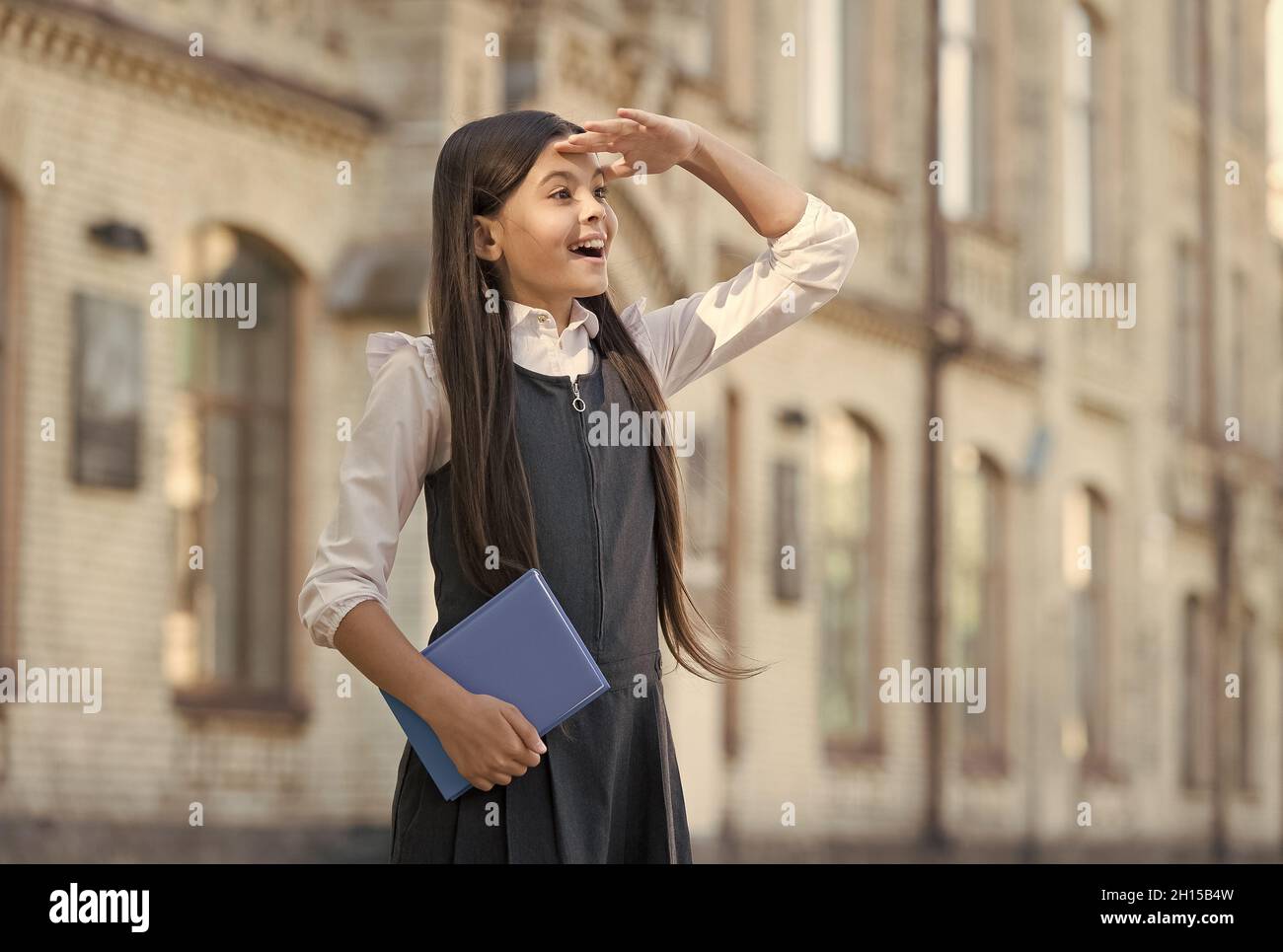 Future smiling here. Happy child with book look ahead. Educational ...