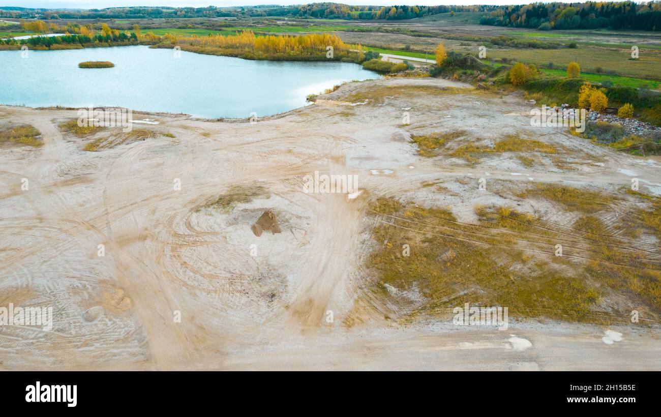 Open pit gravel mining. Little lake or pond of unusual shape with a ...