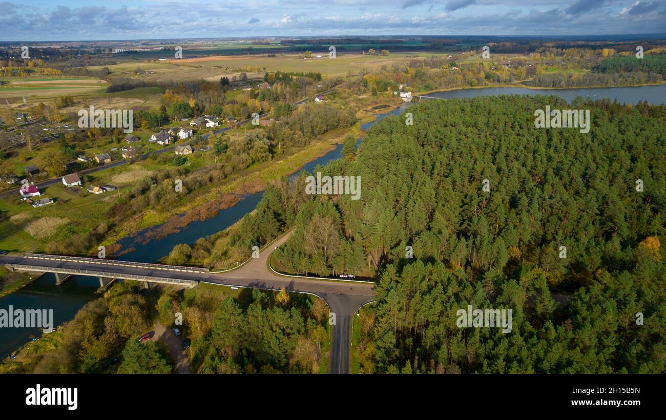 Little town or village with a river surrounded by forests photographed ...