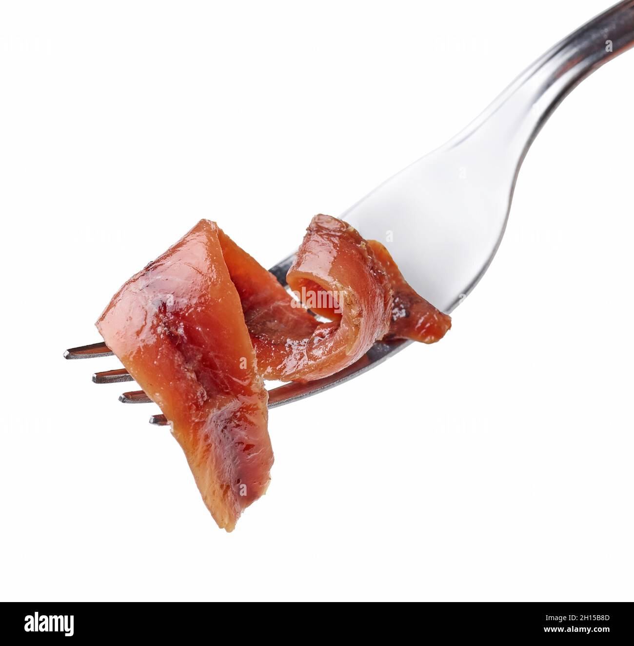 canned anchovy fillet on a fork isolated on white background Stock ...