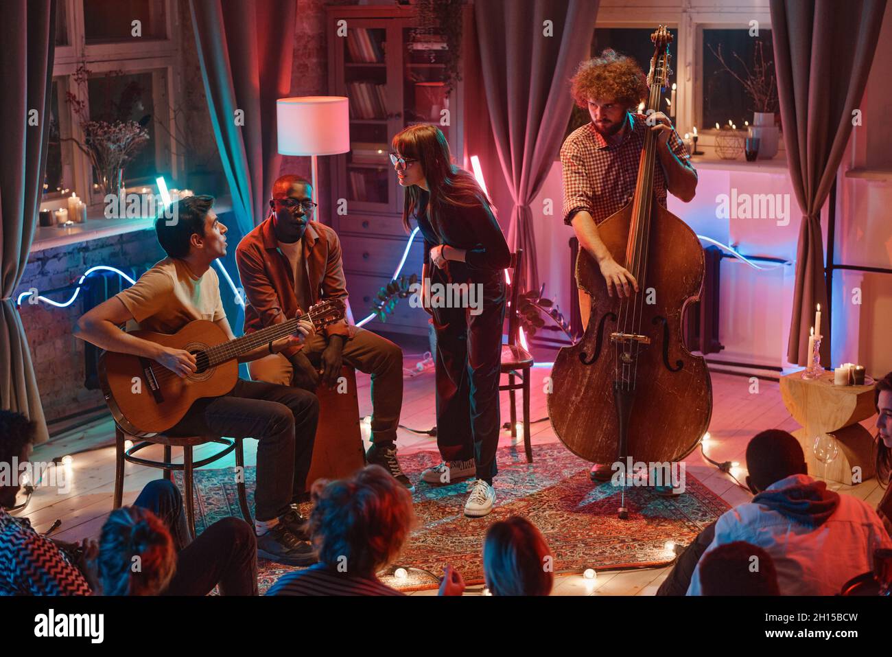 Group of people playing musical instruments for people in the night ...