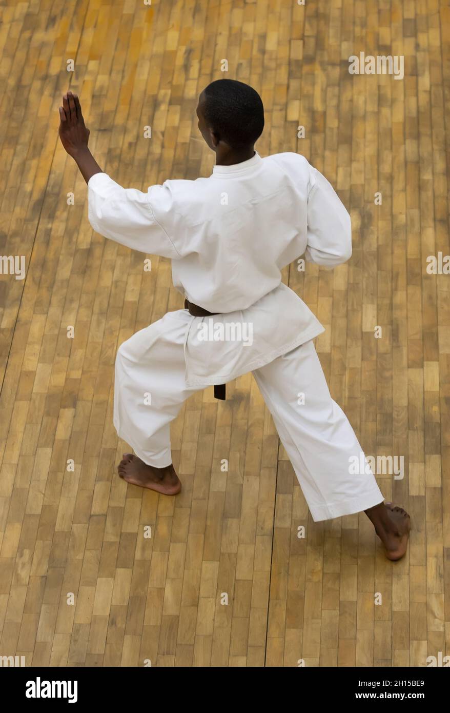 African man performing a kata at a dojo on a wooden floor Stock Photo ...