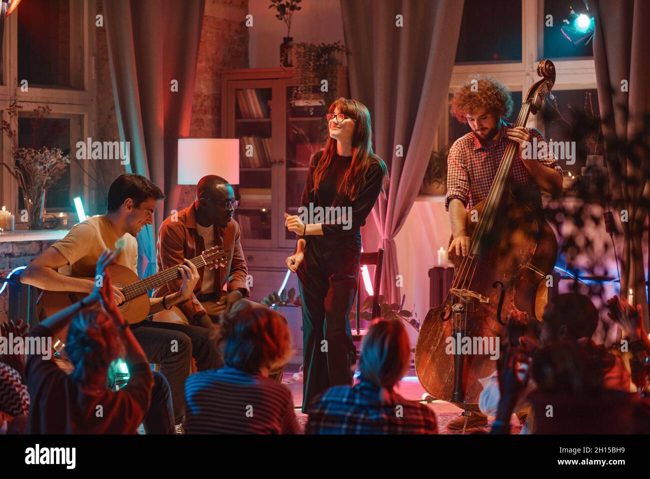 Music band with singer showing their performance for people in the ...