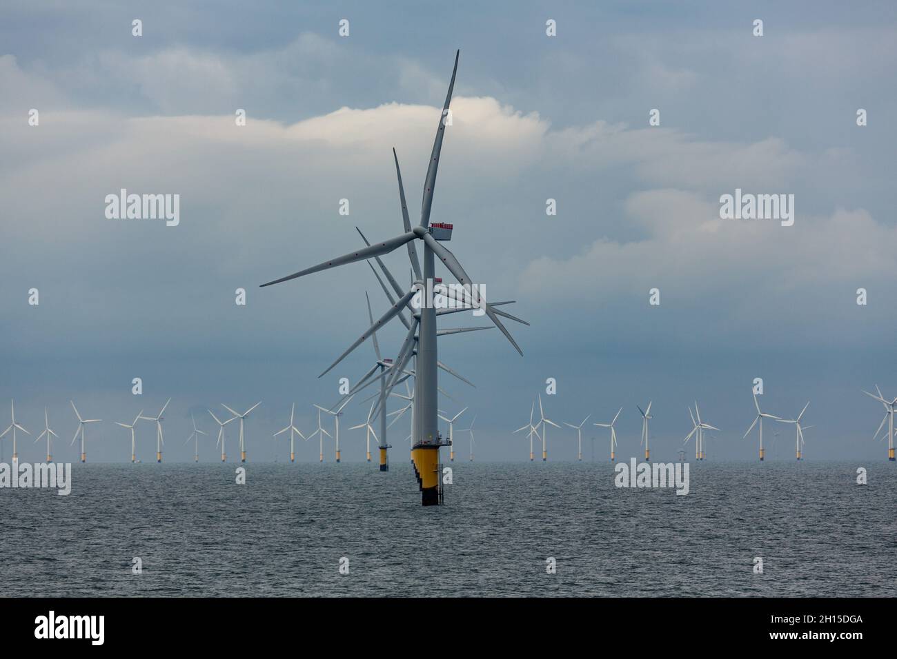 Irish Sea, United Kingdom., . WInd tubives reflecting sunliht in the ...