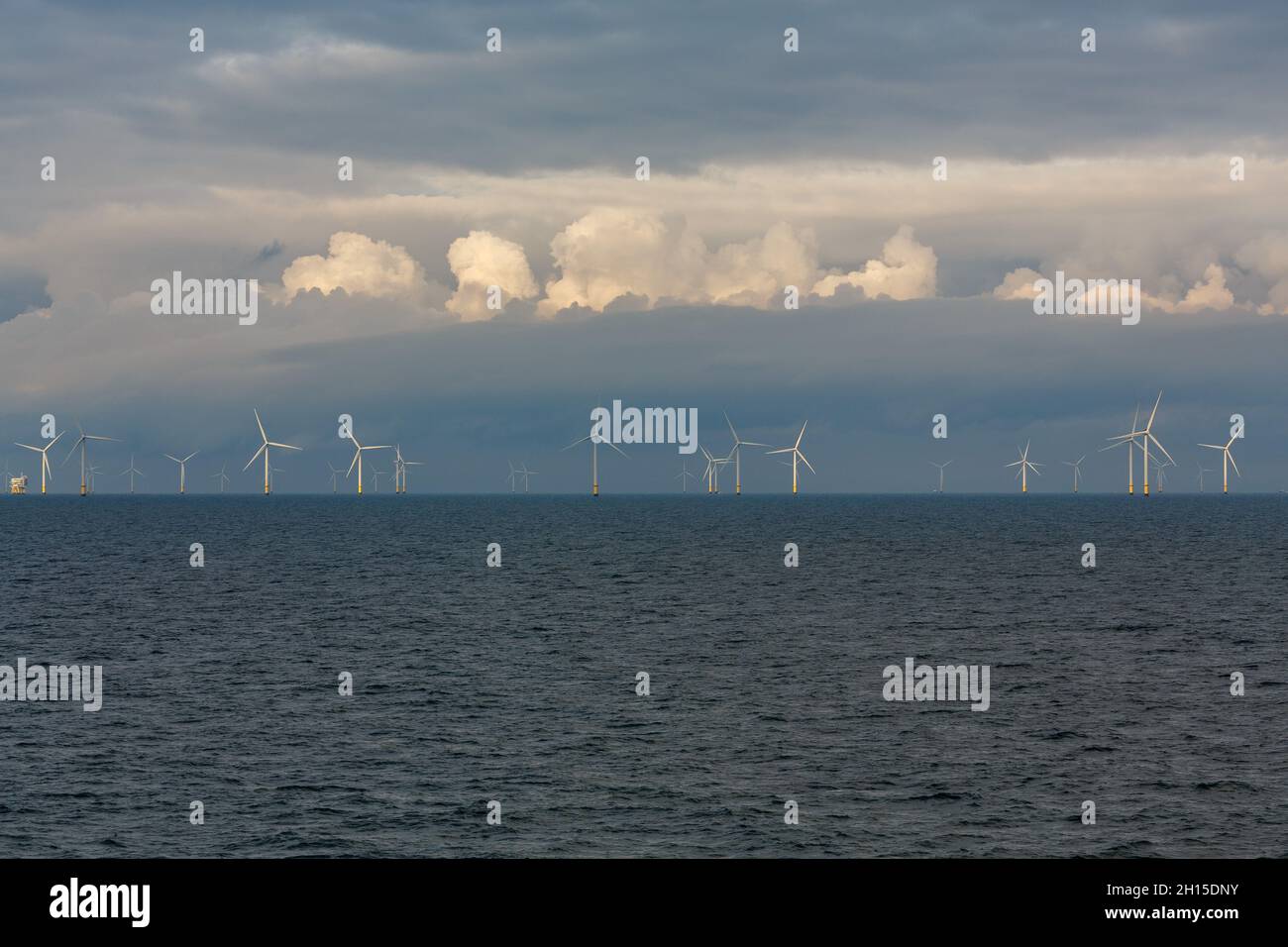 Irish Sea, United Kingdom., . WInd tubives reflecting sunliht in the ...