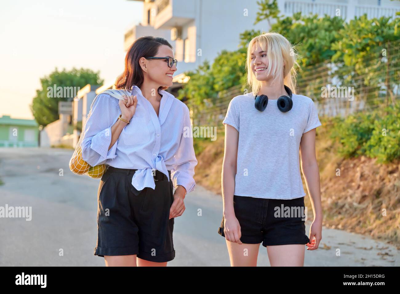 Beautiful talking mom and her teenage daughter outdoors Stock Photo - Alamy