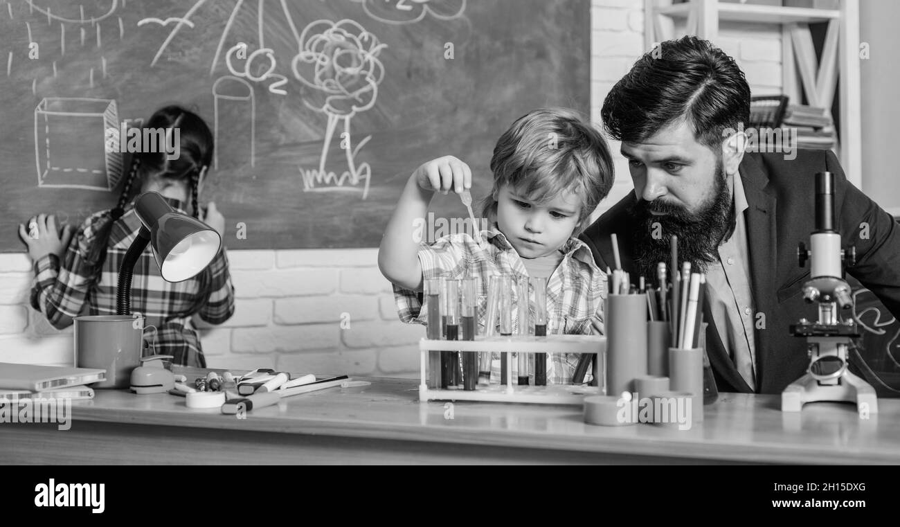 Pupil looking through microscope at the elementary school ...