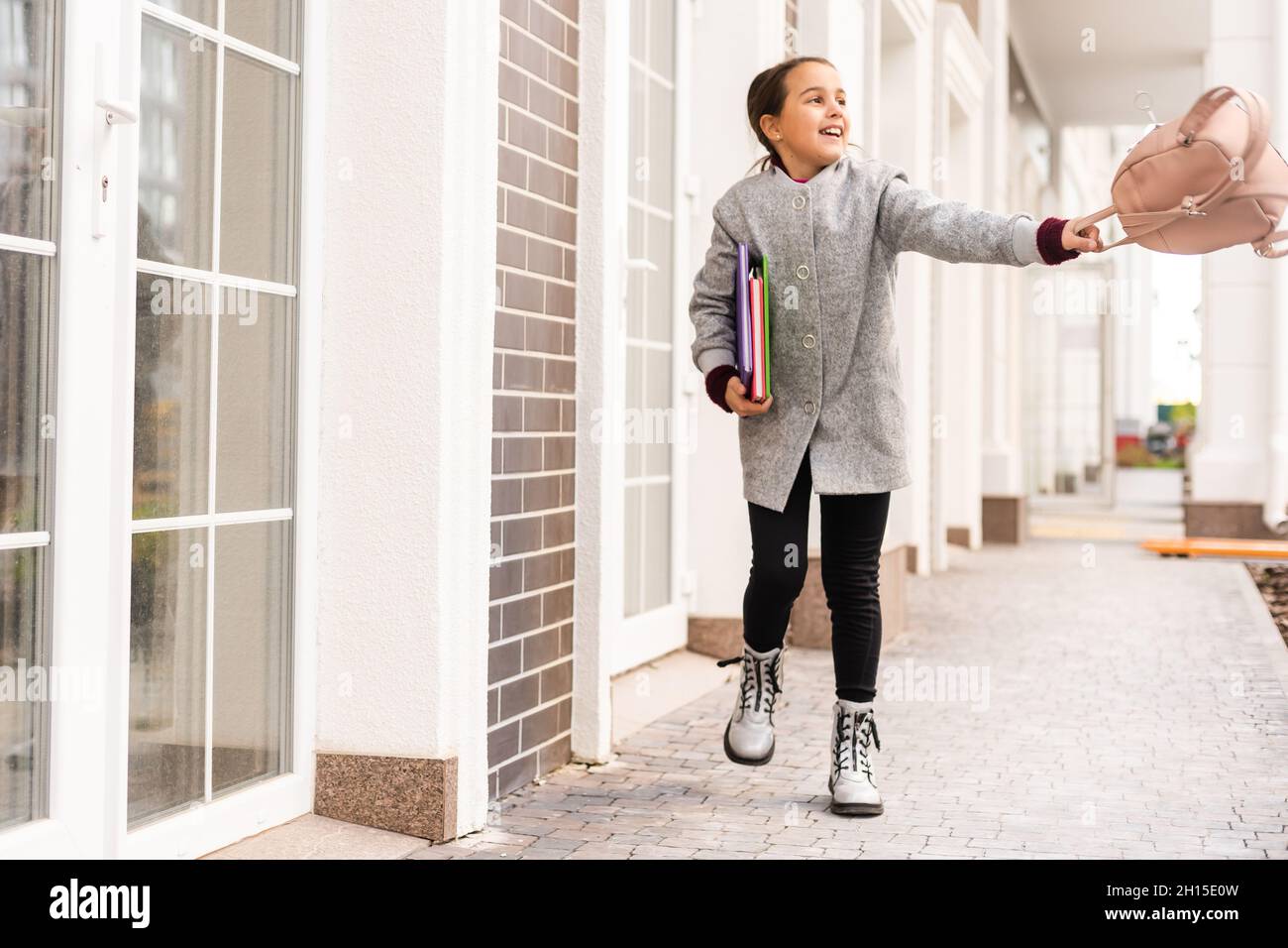 happy little girl running home from school Stock Photo - Alamy