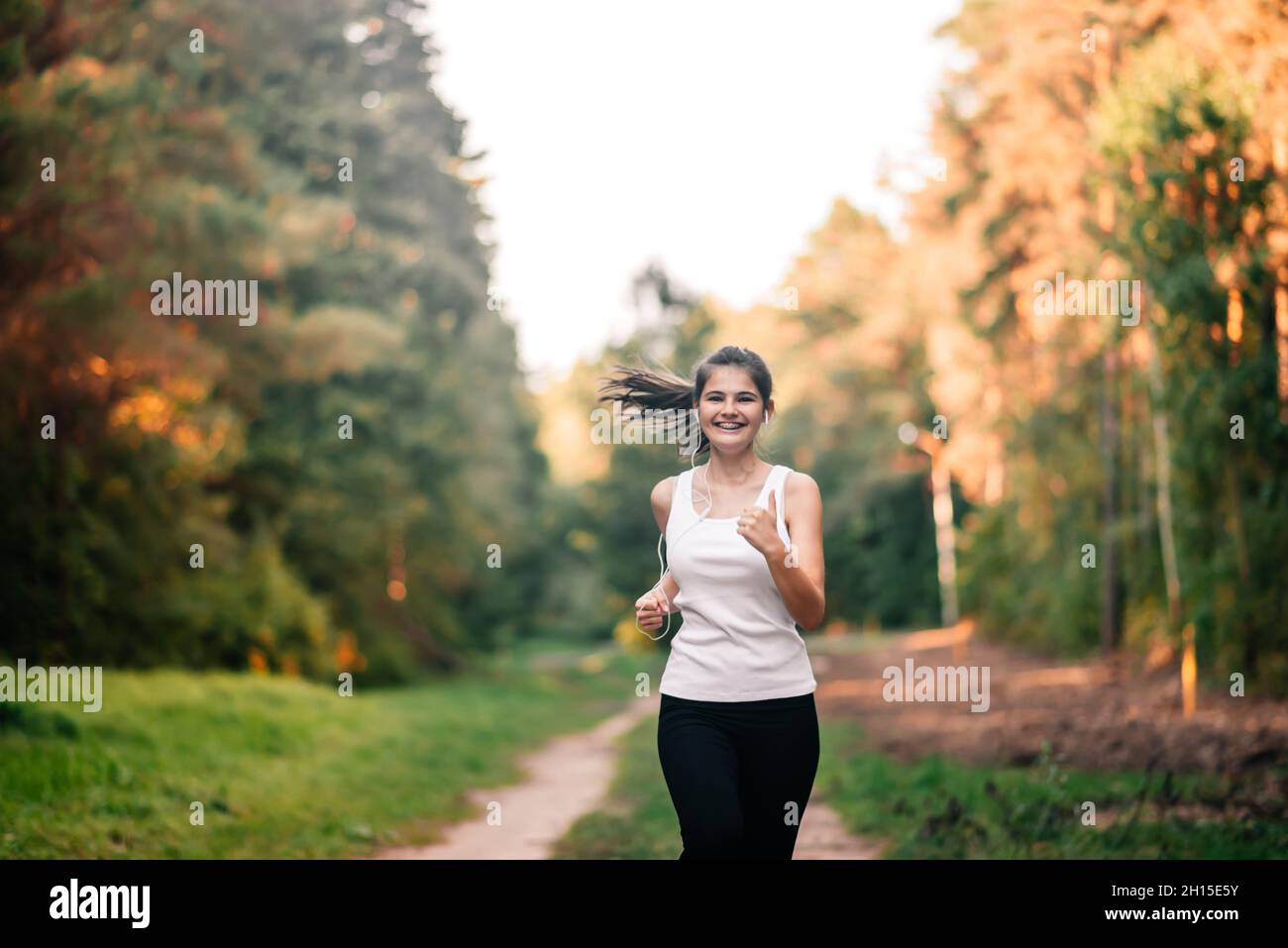 Woman running in autumn fall forest. Healthy lifestyle . Fit ethnic ...