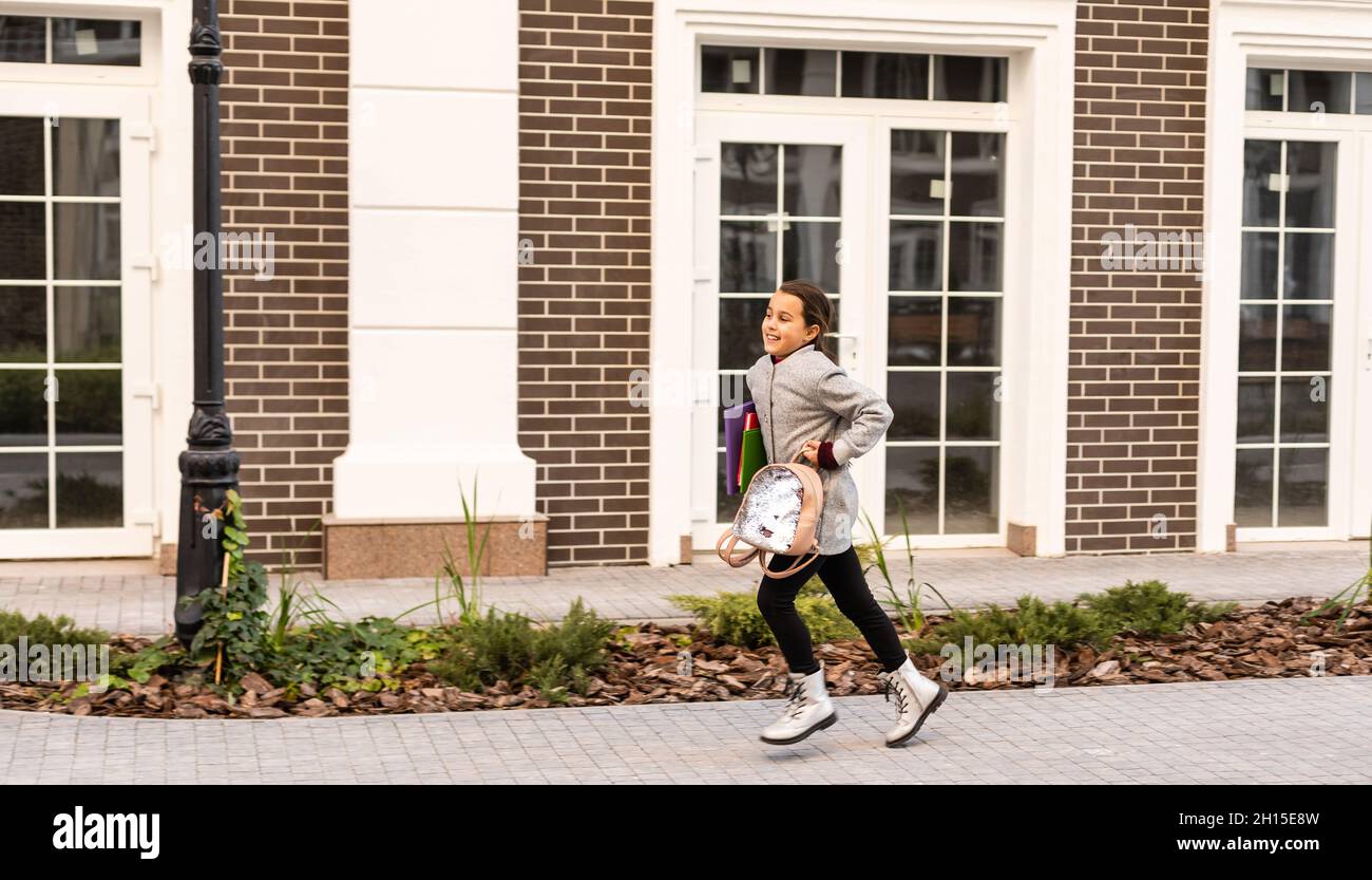 happy little girl running home from school Stock Photo - Alamy