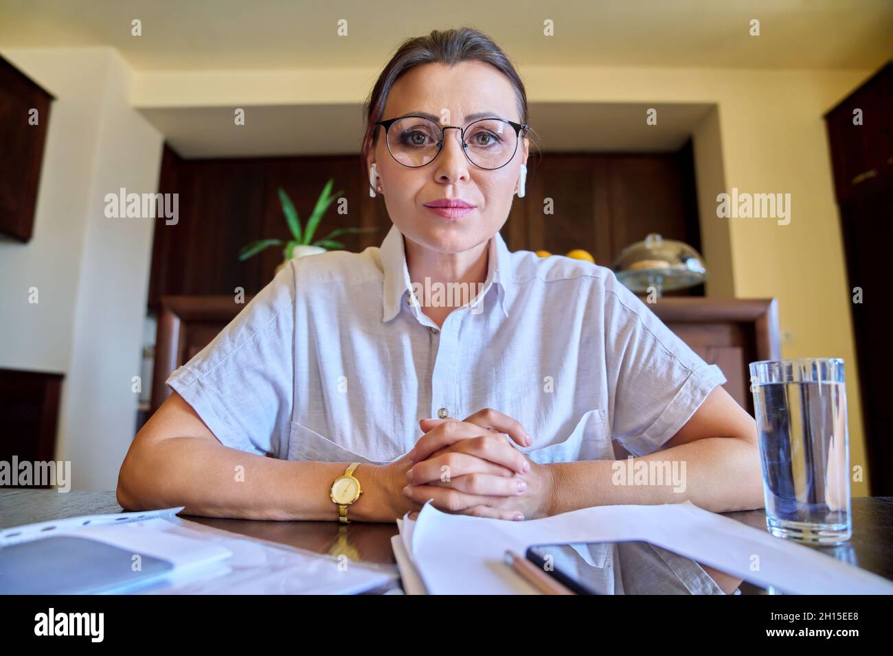 Female psychologist, psychiatrist in headphones looking at webcam ...