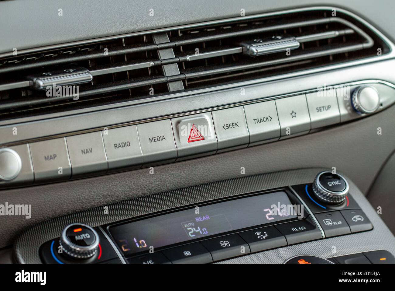 Red triangle hazard light button on car dashboard. Car media buttons ...