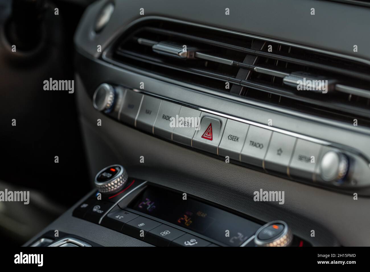 Red triangle hazard light button on car dashboard. Car media buttons ...