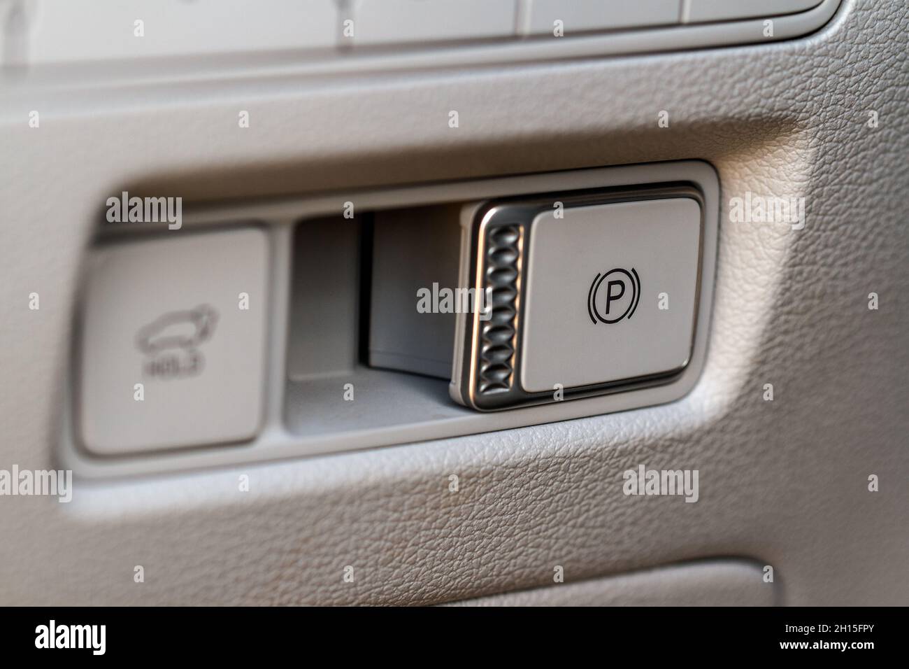 Electric handbrake button of modern car. Modern parking brake close up ...