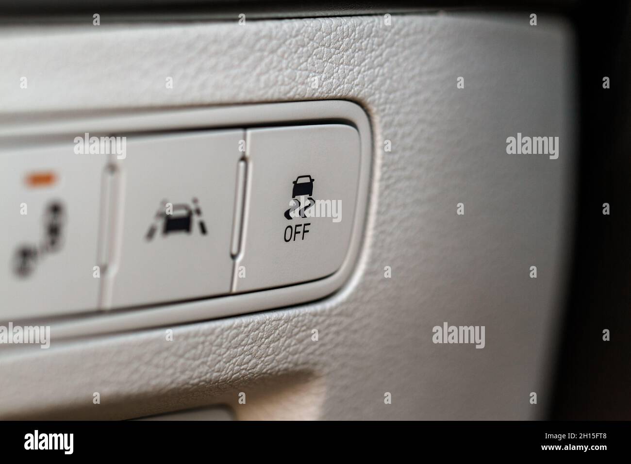 Hand operating ESP (electronic stability program) control close up view ...