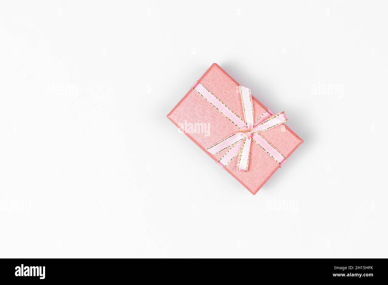 rectangular gift box of pink pastel color with ribbon and bow close-up ...