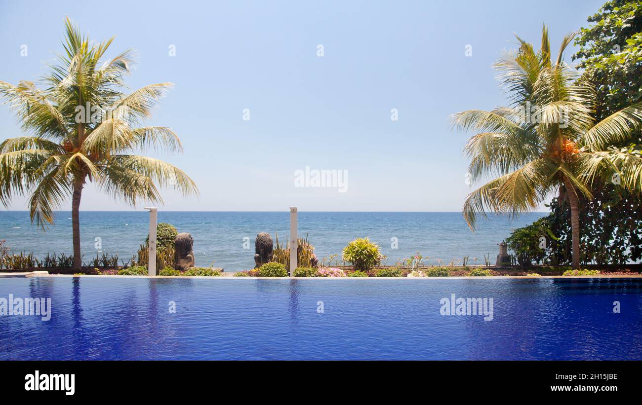 Pool with blue water near the sea. Bali resorts. Territory of the hotel ...