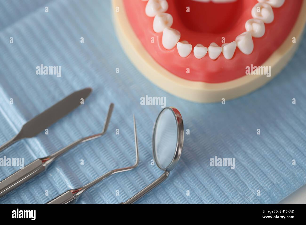 Dental instrument and artificial jaw on table closeup Stock Photo - Alamy