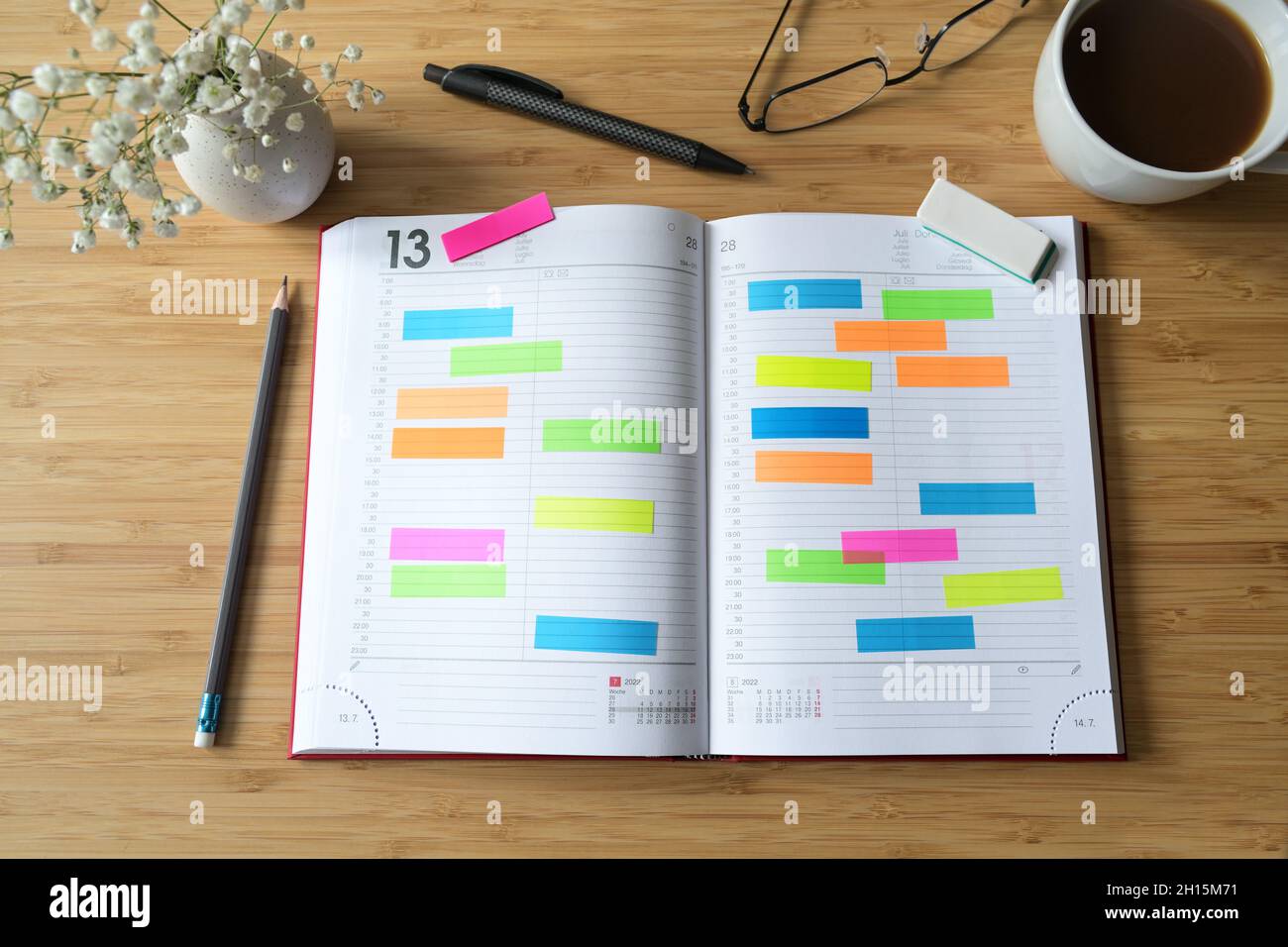 Open diary or appointment calendar with a lot of colorful sticky notes ...