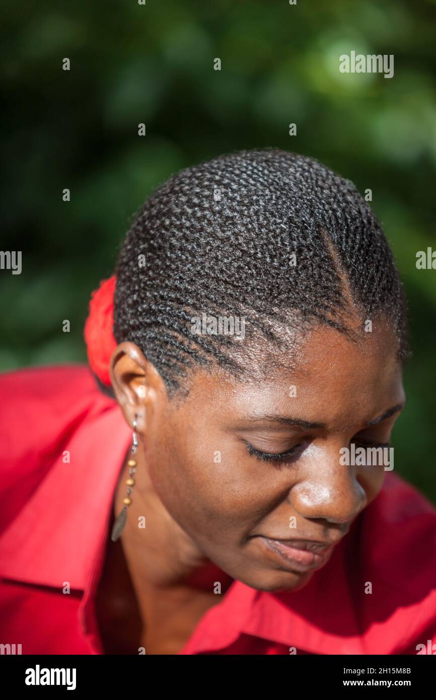 Young African Motswana woman, standing in the garden green vegetation ...