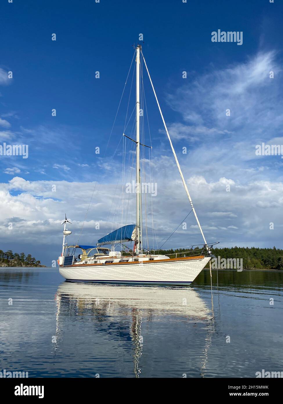 Sailboat in a beautiful and peaceful cove with blue skies. Located in ...