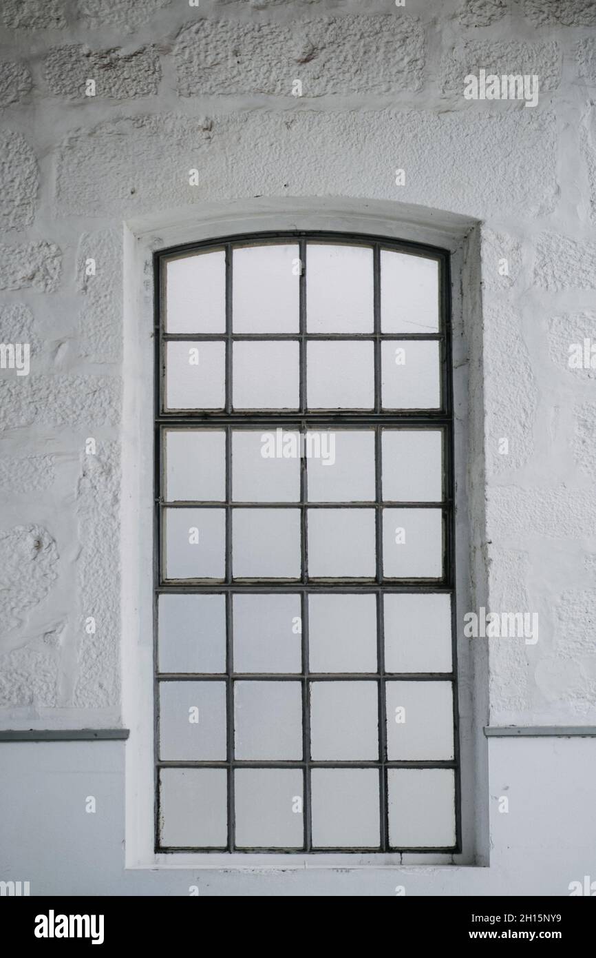 Vertical shot of an arched window with poles Stock Photo - Alamy