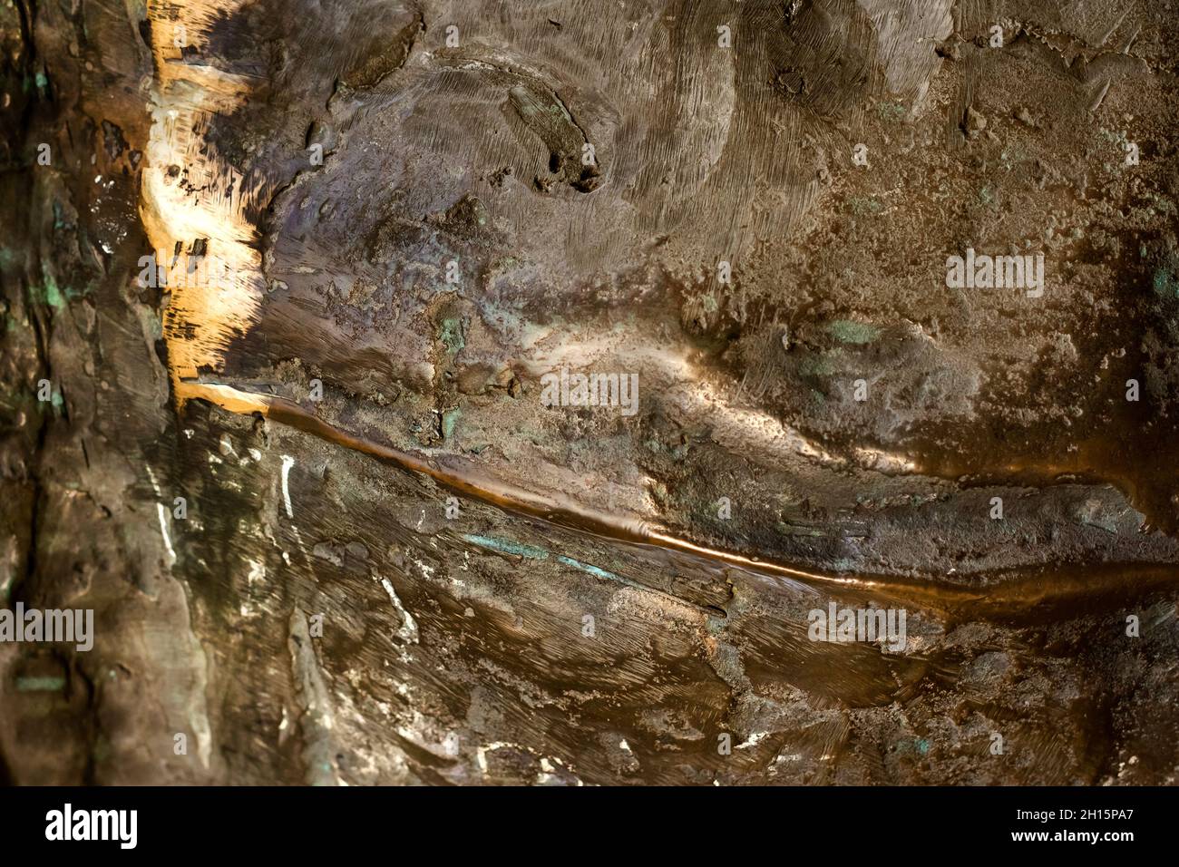 Close-up photo texture of copper or bronze statue material with folds ...