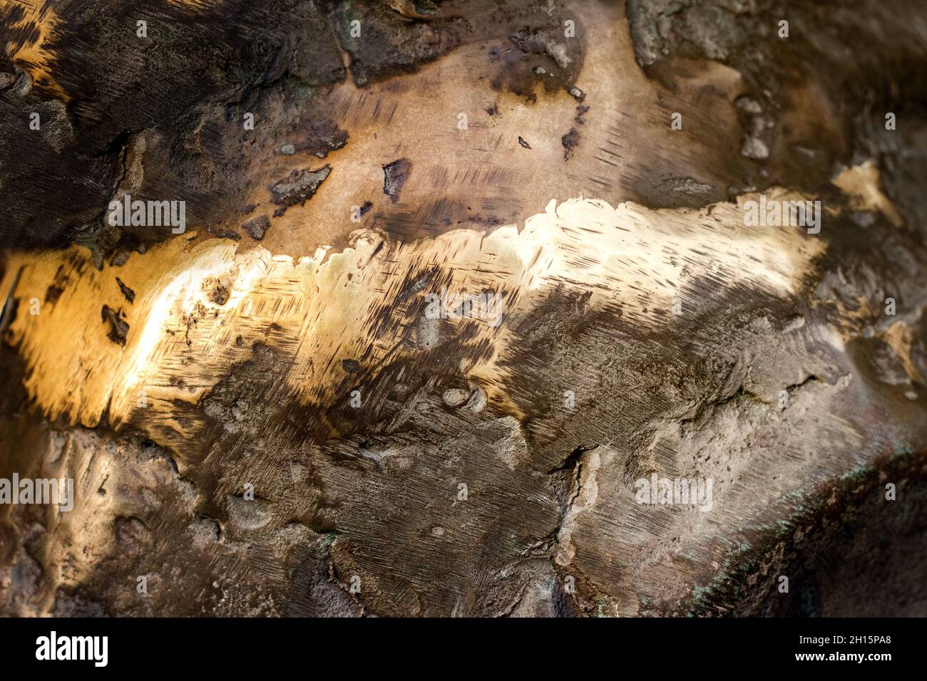 Close-up photo texture of copper or bronze statue material with folds ...