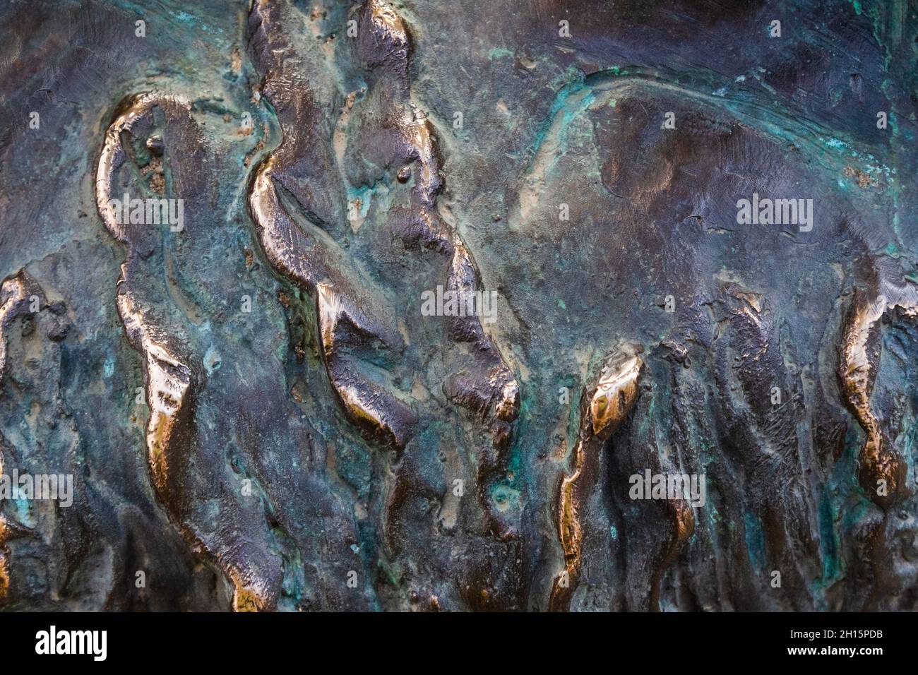 Close-up photo texture of worn and aged copper or bronze statue ...