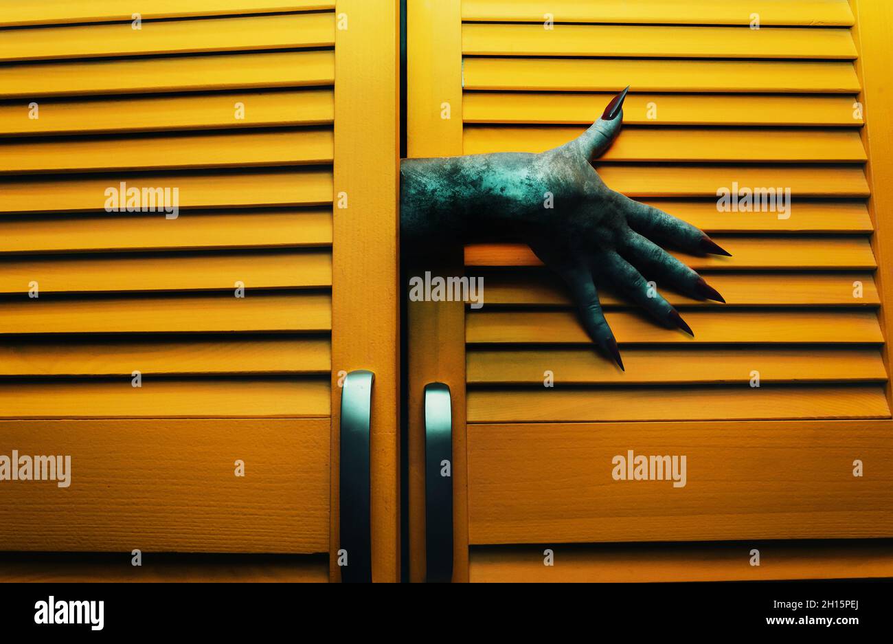 Horror blue toned cupboard doors with scary ghost female monster hands ...