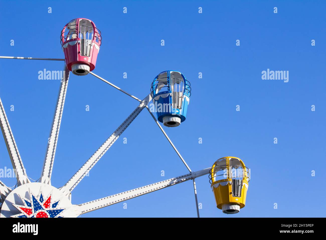 Photo of ferris wheel booths on blue sky background Stock Photo - Alamy