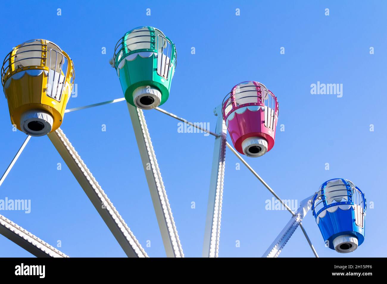 Photo of ferris wheel booths on blue sky background Stock Photo - Alamy
