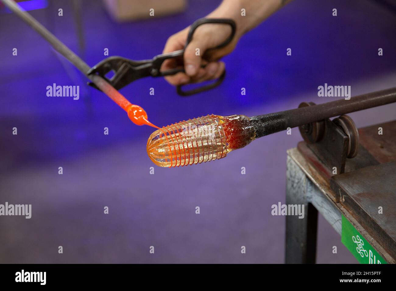 Glass Academy, Dearborn, MI. Spinning the blowpipe while trails of hot ...