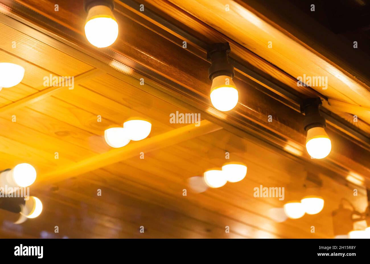 Photo of shining exterior cafe light bulbs Stock Photo - Alamy
