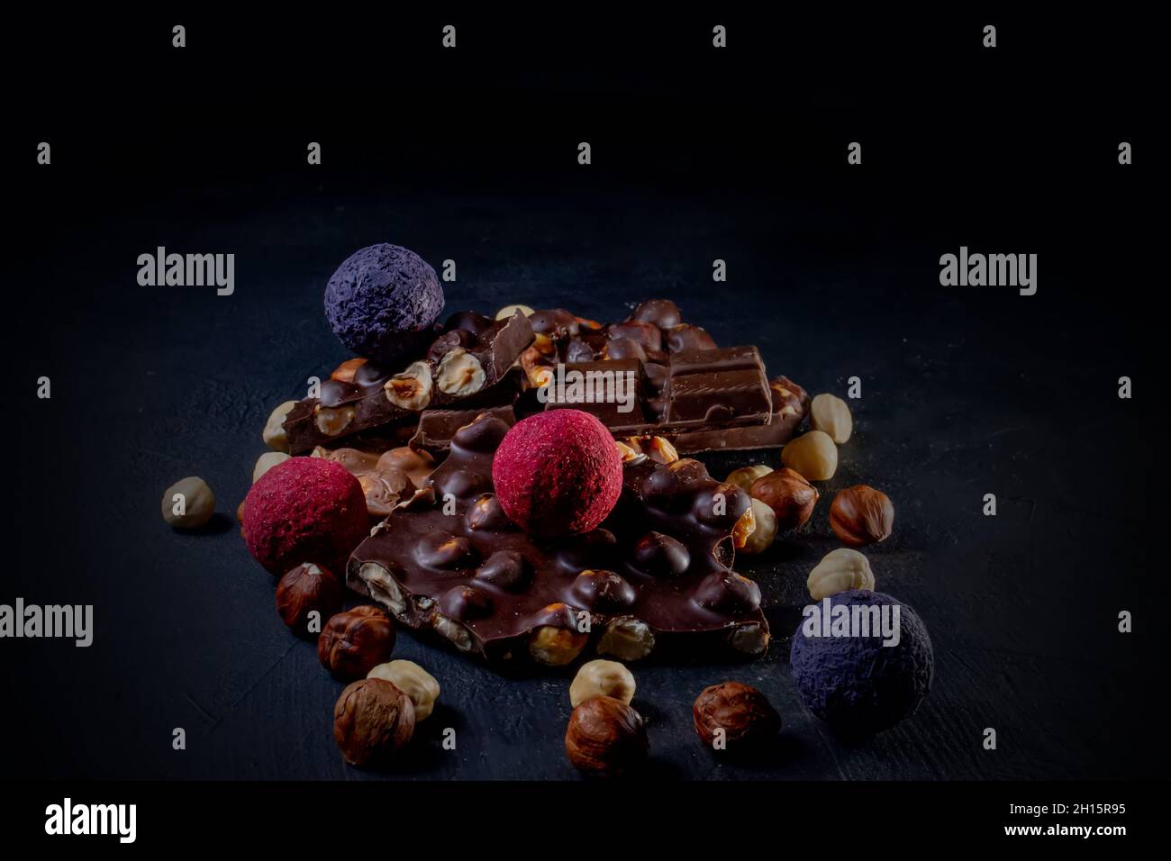 Chocolate bar, crushed pieces of dark chocolate and nuts. Praline ...