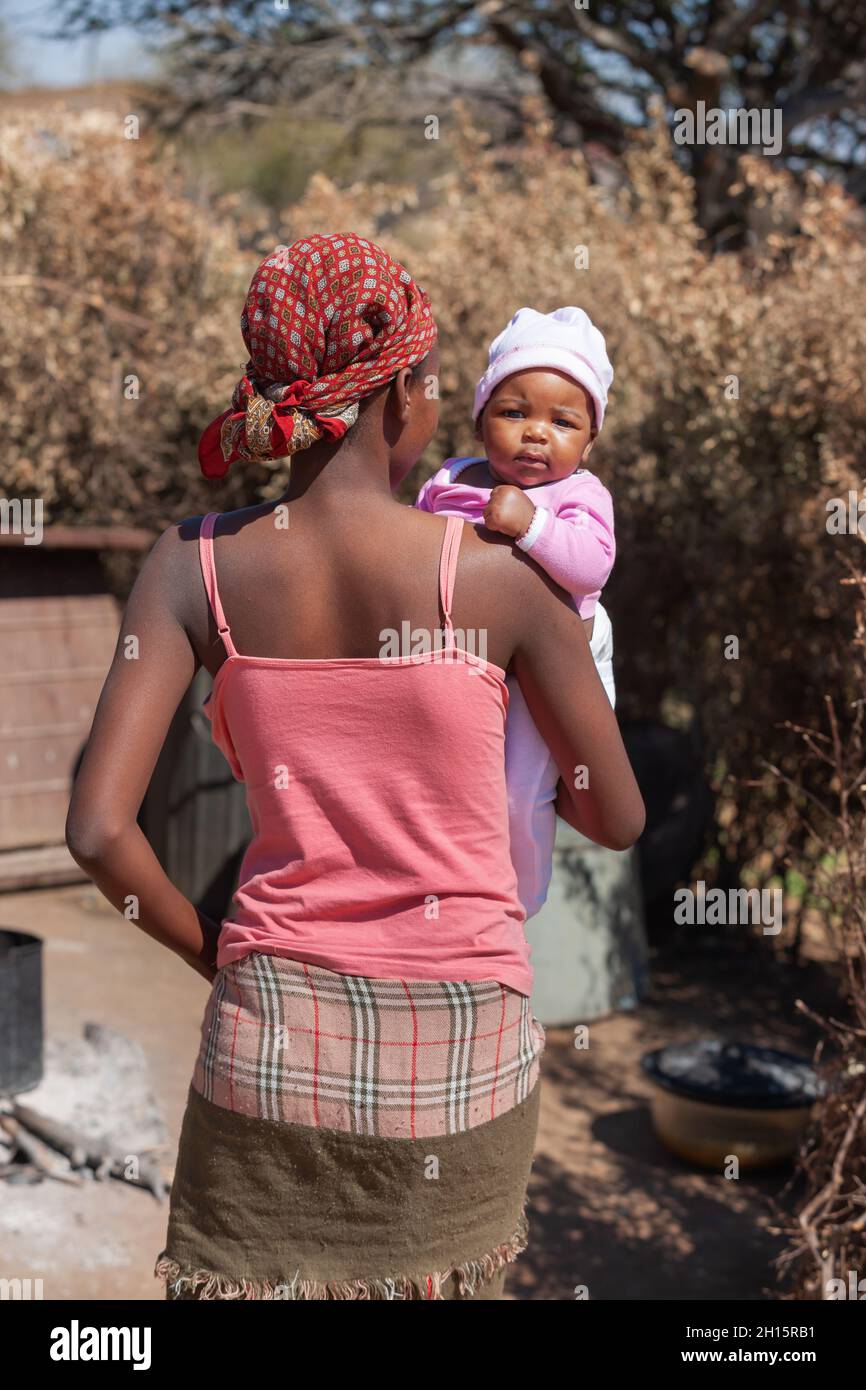 Single young African mother in a village in Botswana, the drama of ...