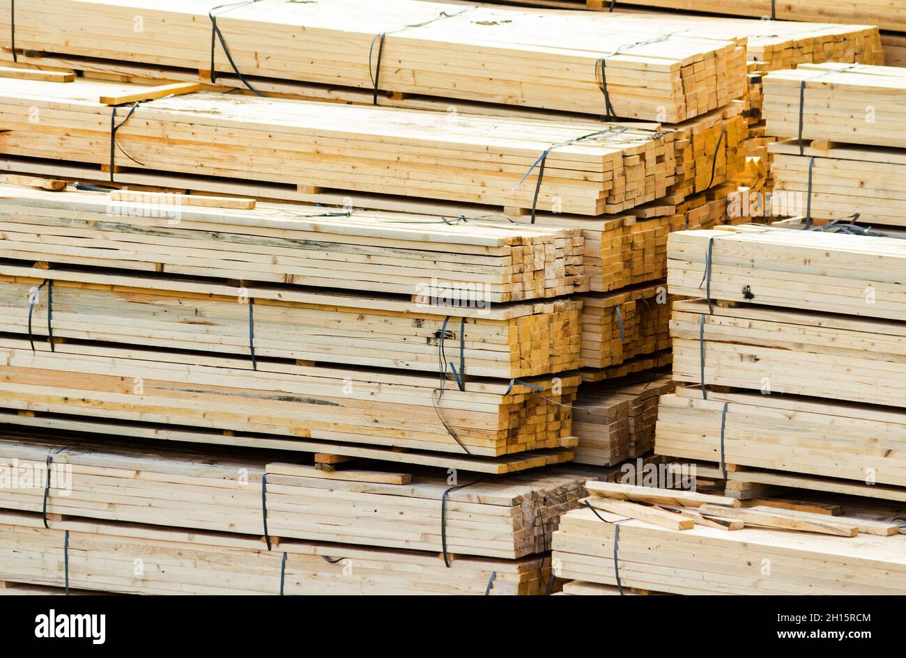Photo of packed stacks of wooden planks and boards Stock Photo - Alamy